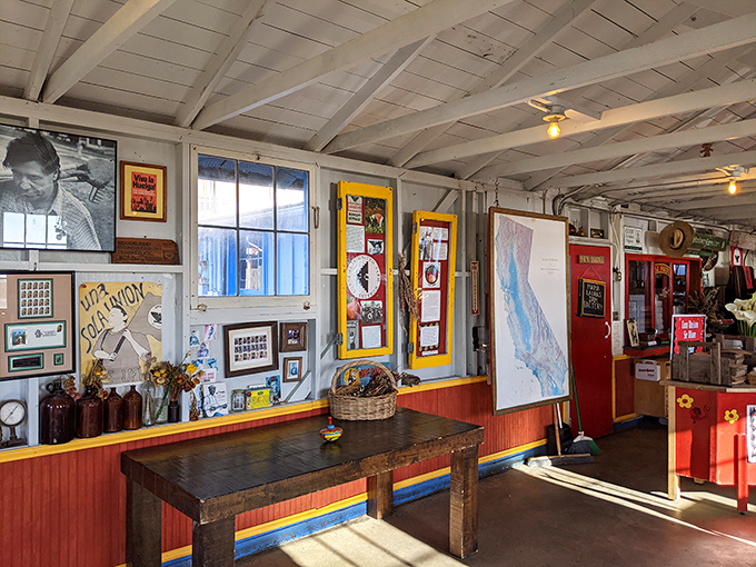 Rustic charm meets agricultural history in this farmstand interior, where sunlight streams through windows onto weathered wood walls.