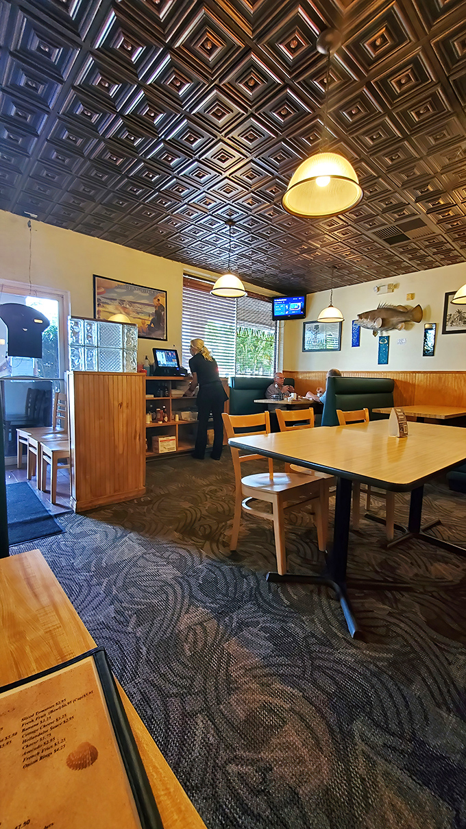 Classic diner aesthetics with those pendant lights and wood paneling. You half expect to see The Fonz walk in and hit the jukebox.
