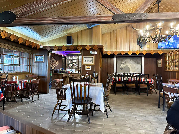 White tablecloths meet rustic charm in this dining room where Western heritage hangs on walls and comfort settles in like an old friend.