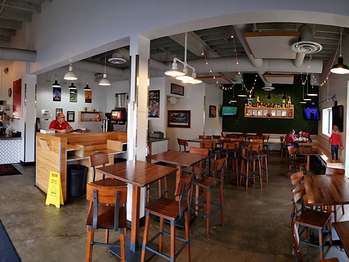 The dining room's warm wood, industrial lighting, and concrete floors create that perfect "discovered cool spot" vibe that makes you feel both hip and comfortable.