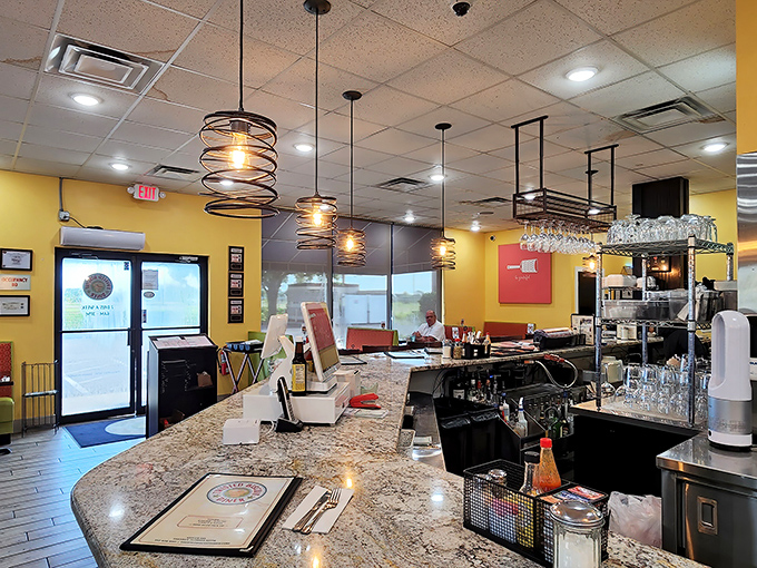 Modern pendant lighting illuminates a diner where calories don't count and diet plans go to die. The yellow walls practically radiate breakfast optimism.