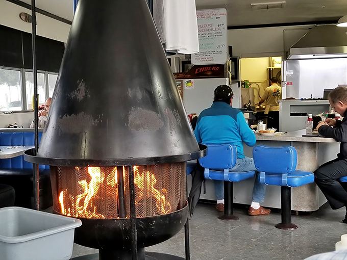 That central fireplace isn't just for show&mdash;it's the beating heart of Chuck's, warming both the space and conversations.