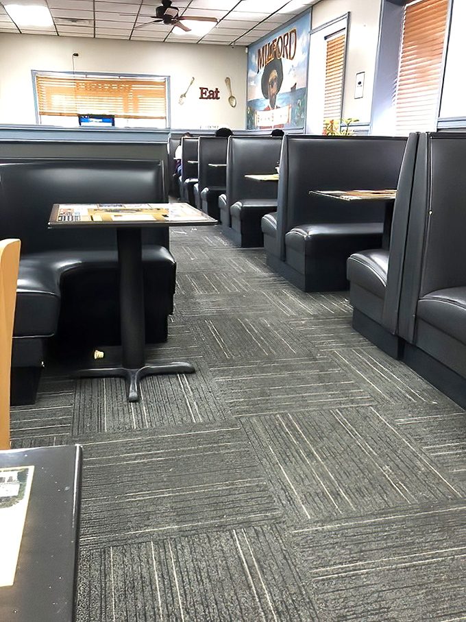 Classic diner booths&mdash;where strangers become neighbors and calories don't count. The "Milford" sign reminds you that local pride is always on the menu.