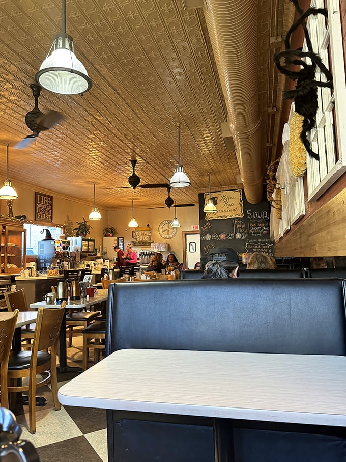 The pressed tin ceiling catches morning light while pendant lamps create the perfect glow for serious breakfast contemplation.