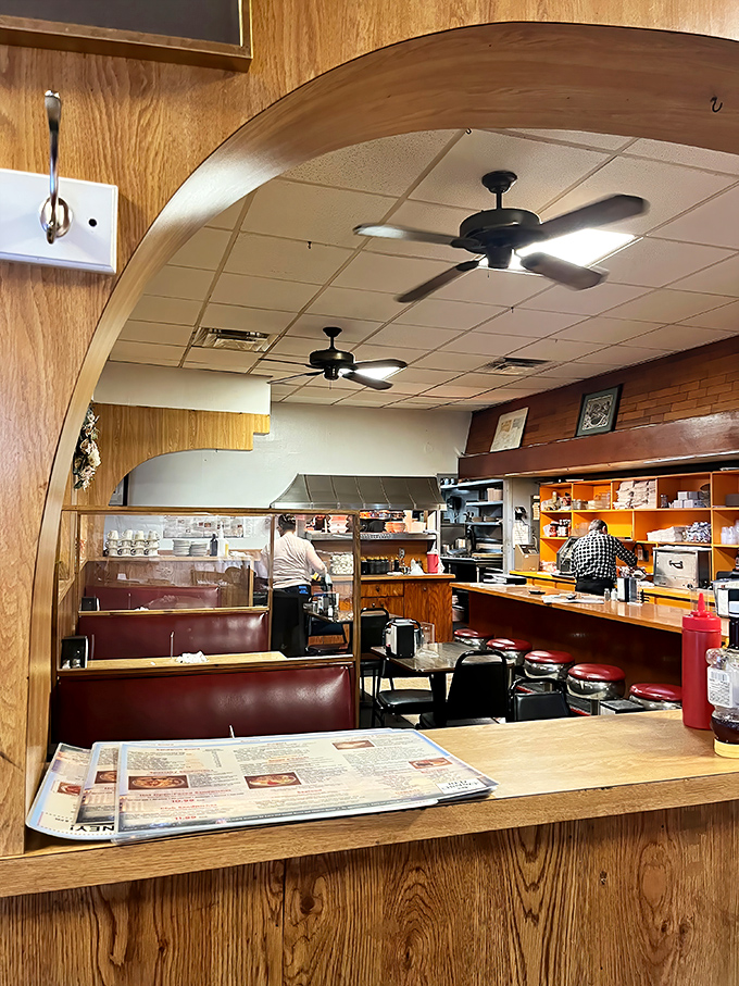 That curved wooden archway separates the dining room from the kitchen&mdash;like a proscenium arch for the daily theater of comfort food.