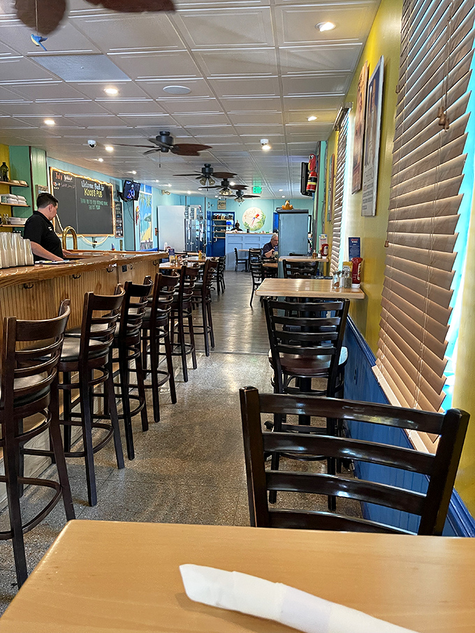 The bar area offers a front-row seat to the action. Those high-backed chairs practically whisper, "Stay awhile, order another round."