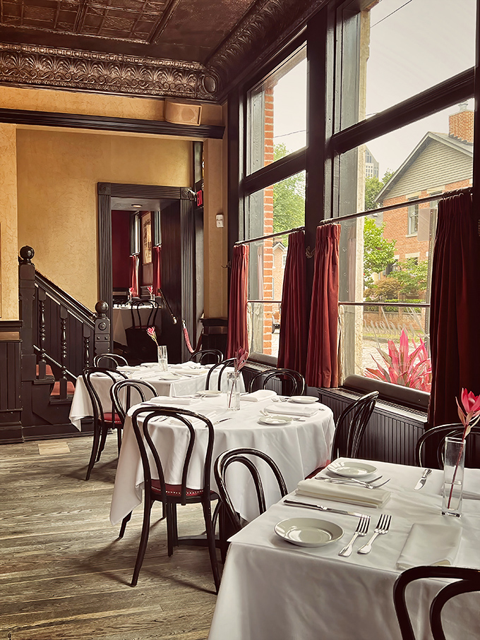 Sunlight streams through tall windows, casting a glow on white tablecloths that says, "Yes, this meal is going to be worth it."