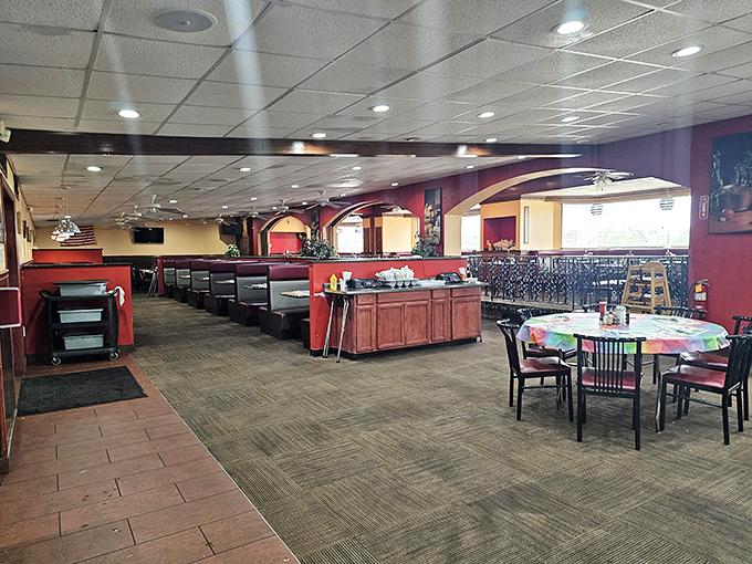 The spacious dining area balances privacy and community, with burgundy booths that have cradled countless family celebrations and road-weary travelers.