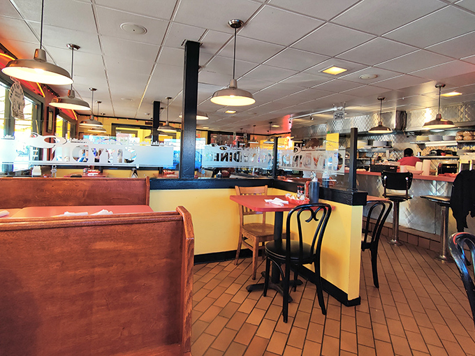 The diner's open layout invites you into a world where yellow walls and pendant lights create the perfect backdrop for morning conversations.