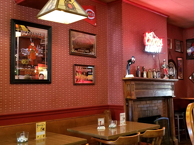 The fireplace room feels like stepping into a Norman Rockwell painting, where sports memorabilia and vintage wallpaper create a quintessentially American tableau.