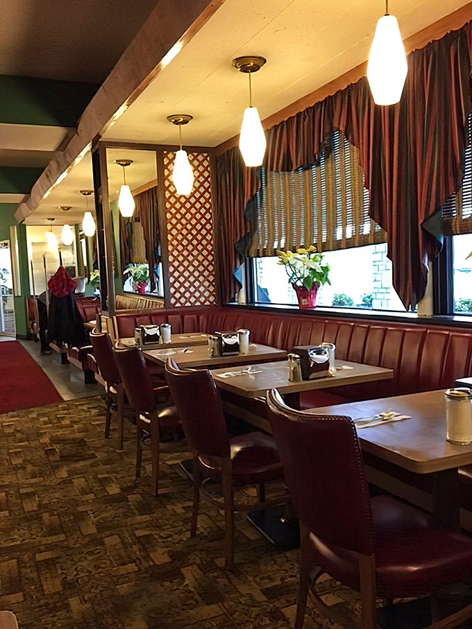Pendant lights cast a warm glow over booths where countless life decisions have been made over pie and coffee.