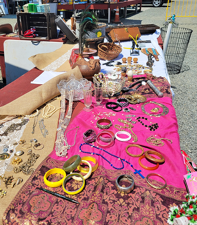 A kaleidoscope of vintage jewelry sprawls across vibrant fabrics, each bracelet and necklace whispering tales of past celebrations.