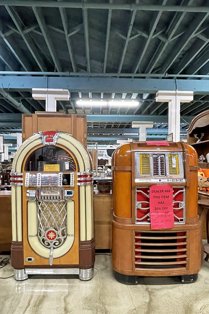 Dueling jukeboxes stand like sentinels of sound history, ready to transport you back to sock hops and soda fountains with the press of a button.