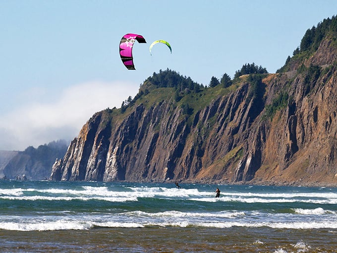 Kitesurfers dance with the wind against Neahkahnie's dramatic cliffs. Who needs a gym membership when you've got this natural playground?