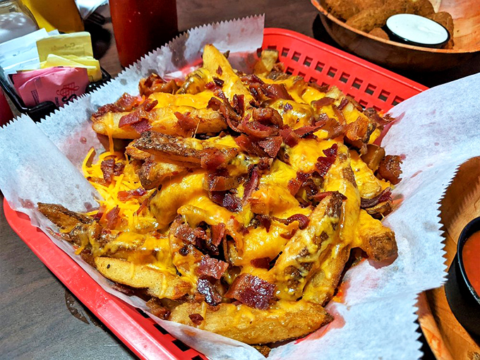 Loaded fries that make French diplomats weep with envy. The cheese-to-bacon ratio here deserves a mathematical theorem named after it. 