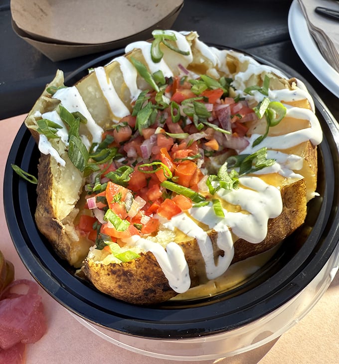 A loaded potato that's been promoted to main character status. The sour cream drizzle is just showing off.
