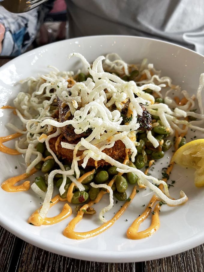 A tower of flavor that defies gravity! Crispy mahi topped with crunchy vegetables and drizzled sauces that make architecture delicious.