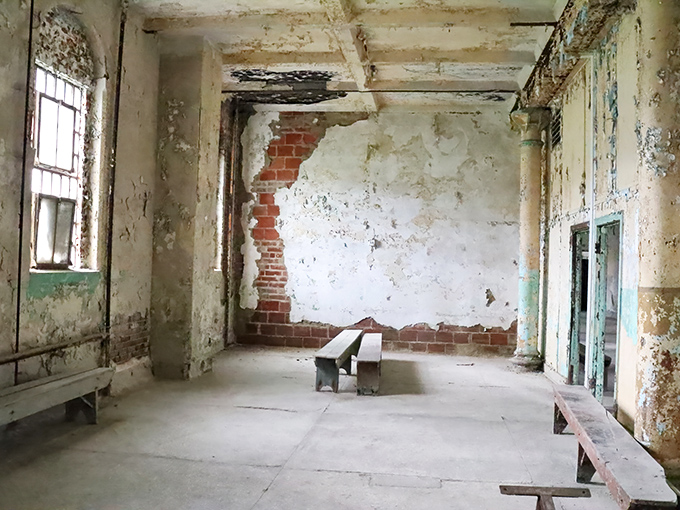 A room where time stopped decades ago. The crumbling walls and simple benches speak volumes about institutional austerity.