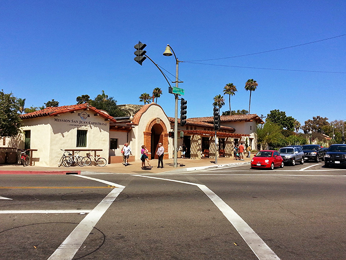 Mission San Juan Capistrano's entrance welcomes visitors with the architectural equivalent of a warm, centuries-old embrace.