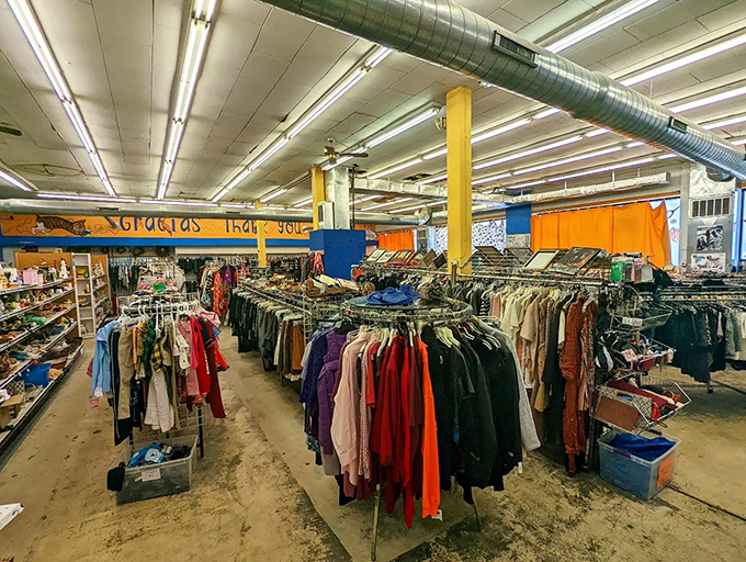 "Gracias, Thank You" proclaims the cheerful mural above a sea of clothing. The store's gratitude to its community creates a shopping experience that feels meaningful.