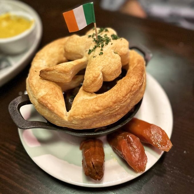 Not just a pie—a masterpiece of pastry architecture. The Irish flag stands proudly atop what might be the most patriotic use of puff pastry in Florida.