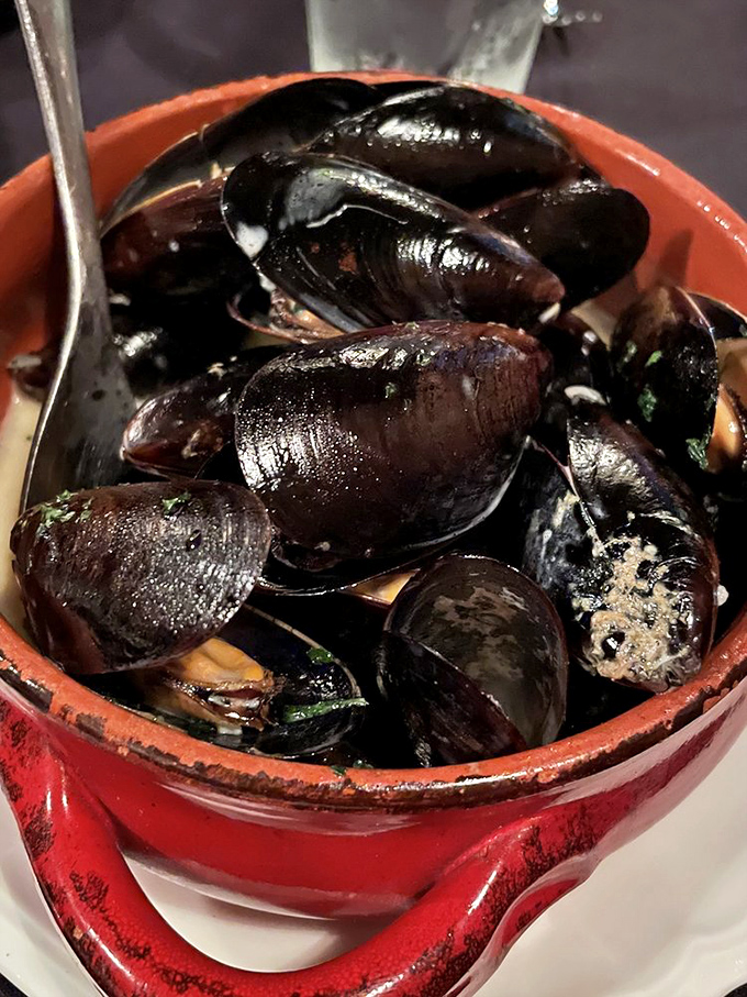 These mussels aren't just swimming in sauce&mdash;they're performing synchronized flavor diving in a pool of garlicky goodness.