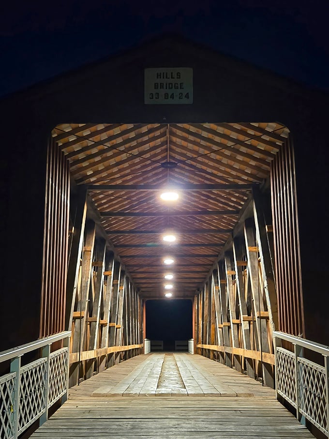 After dark, the bridge transforms into a warmly lit wooden sanctuary, its geometric patterns creating a cathedral-like atmosphere for nighttime explorers.