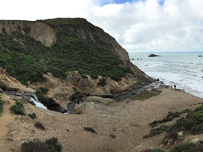 A bird's-eye perspective reveals the falls' secret location, tucked into coastal cliffs like California's best-kept treasure map come to life.