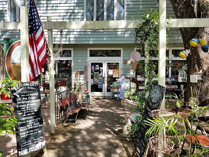 Old Florida Cafe's entrance beckons with promises of home cooking and local gossip. The shaded pathway offers respite from Florida's relentless sunshine.