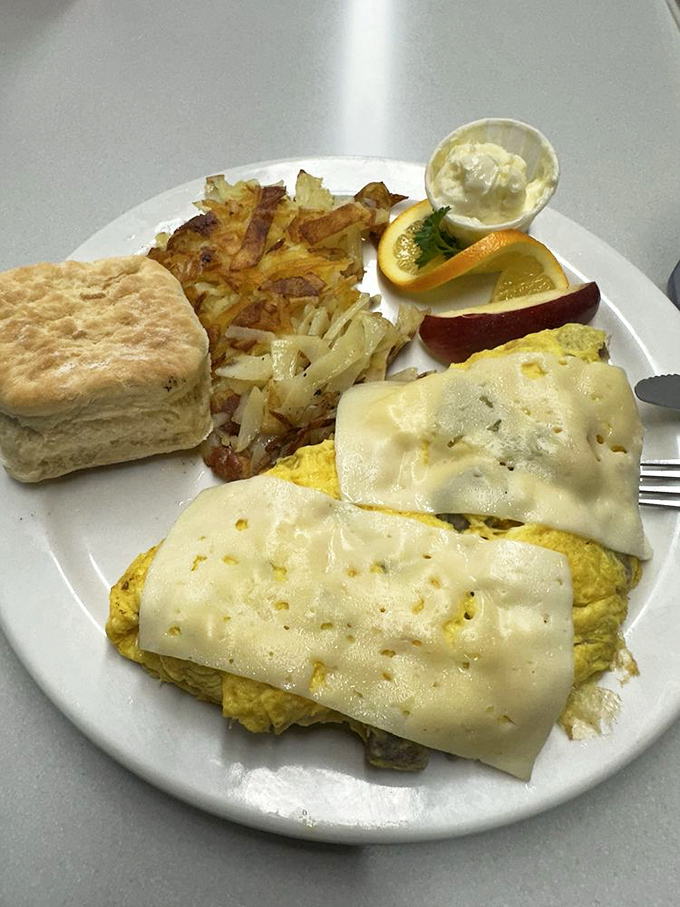 This cheese-blanketed omelet with crispy hash browns and a perfect biscuit is the breakfast equivalent of hitting a culinary jackpot.
