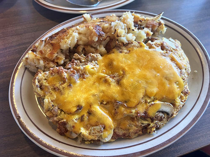 An omelette folded with such care, it resembles a golden breakfast envelope filled with deliciousness.