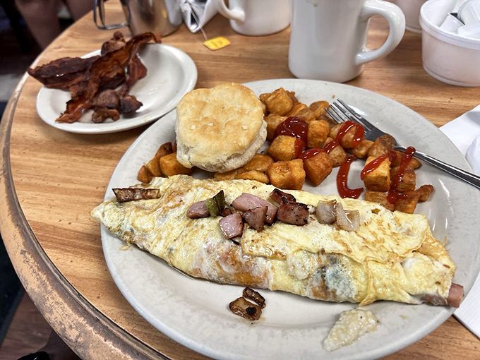 An omelet that knows its purpose in life: to deliver maximum flavor in every bite. That biscuit isn't just a side—it's an edible Southern hug.