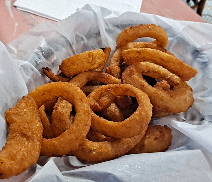 Onion rings with the structural integrity of Olympic medals and twice the satisfaction when you bite into their golden-battered glory.