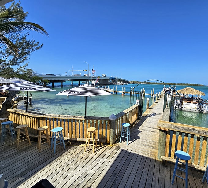 Bar stools with a view that makes you forget what you ordered. Paradise isn't always about white tablecloths&mdash;sometimes it's weathered wood and turquoise waters.