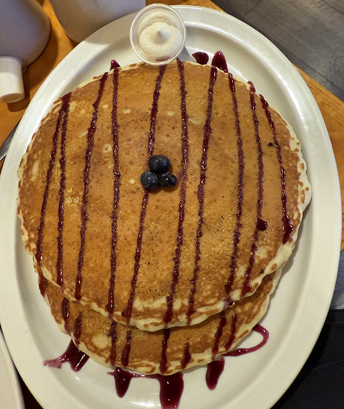 Pancakes that don't know the meaning of "small portion." Those blueberries and berry syrup transform breakfast into an event worth celebrating.