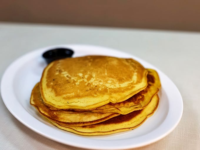 Pancakes stacked higher than your weekend expectations. These golden discs of joy are what breakfast dreams are made of.