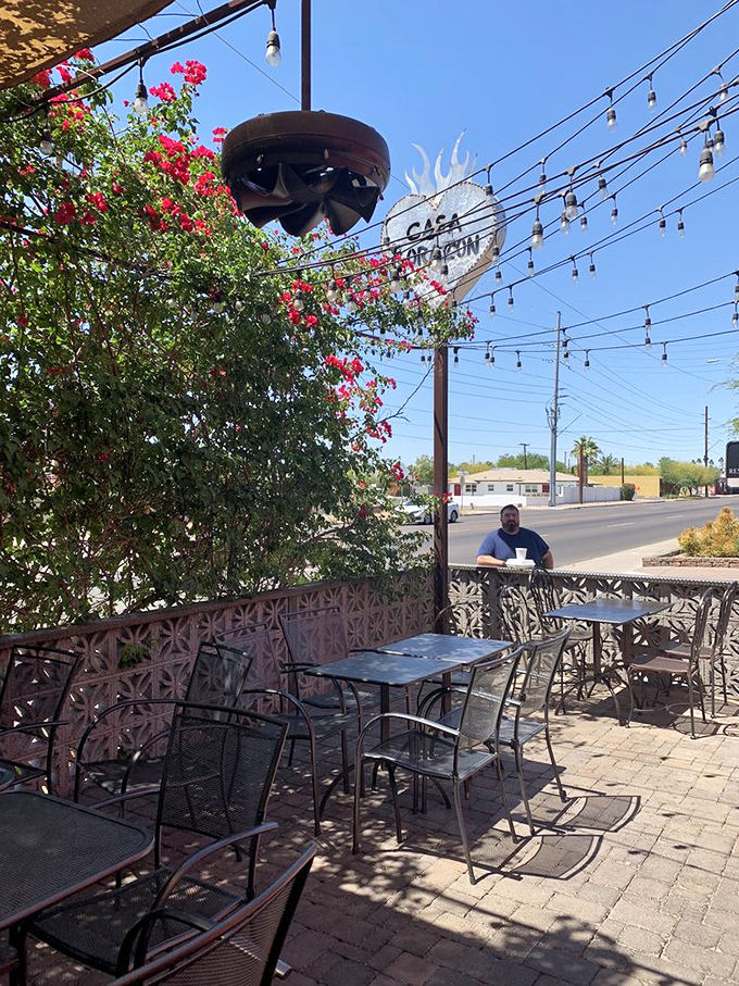 The patio offers string lights, flowering bougainvillea, and just enough shade to make outdoor dining in the desert seem like a completely reasonable idea.