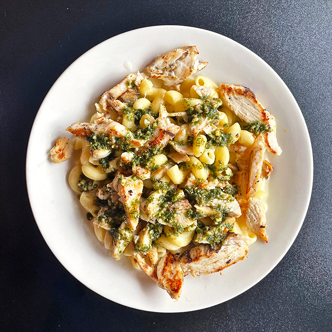 Pasta that's dressed better than most people at a wedding. This pesto chicken dish brings Mediterranean sunshine to Midwest tables.