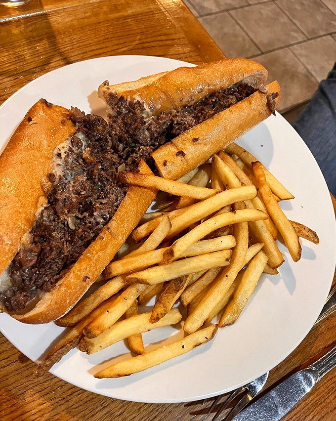 The Philly cheesesteak alongside perfectly golden fries. Not just a sandwich but a regional handshake&mdash;a proper introduction to Pennsylvania's flavor personality.