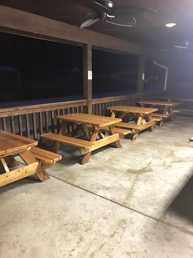 As night falls, the empty picnic tables wait patiently for tomorrow's crowd. Even in darkness, this riverside dining room maintains its humble charm.