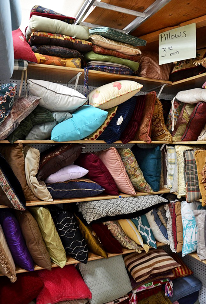 The pillow section: where textile dreams and decorative schemes come together at $3 each. From floral patterns to geometric designs, these cushions await their second act.