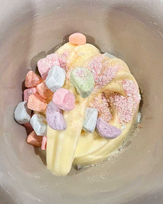 Soft-serve ice cream becomes an art form when adorned with colorful marshmallows &ndash; childhood nostalgia served in a grown-up portion.