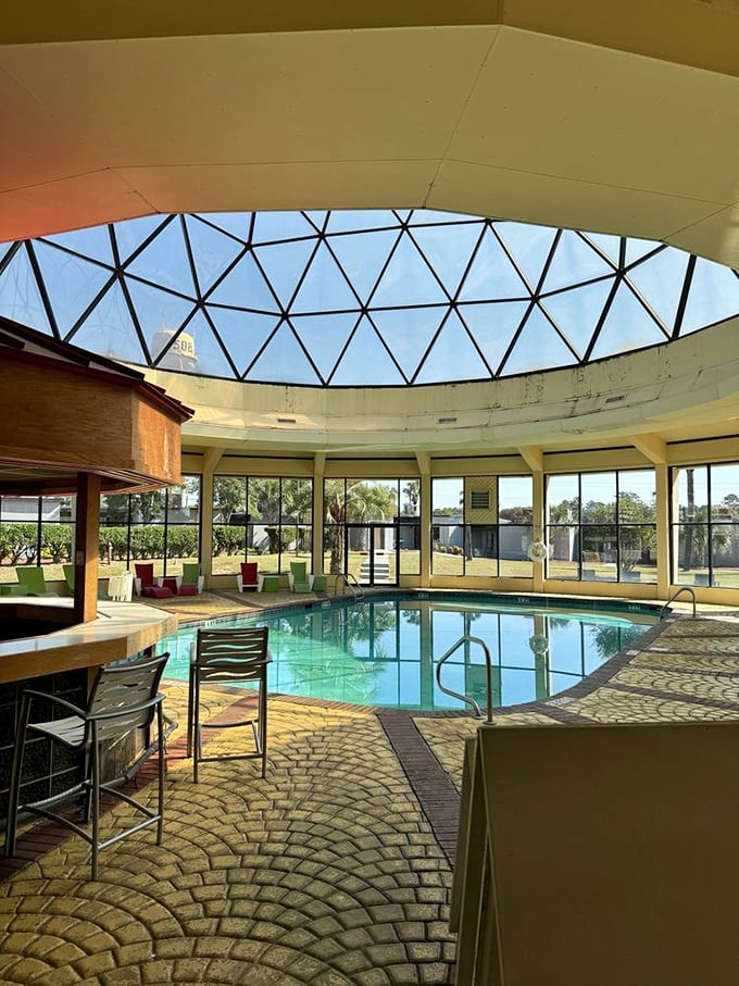 The Pleasure Dome's indoor pool offers an unexpected oasis of tranquility amid the roadside chaos. Swim beneath sky-blue geometric wonder.
