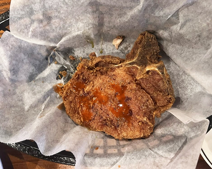 That's not just a pork chop&mdash;it's a statement piece. Crispy, seasoned perfection that extends well beyond the boundaries of its plate.