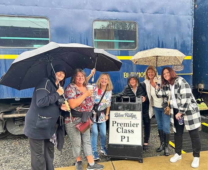 Rain can't dampen the spirits of these Premier Class passengers, armed with umbrellas and anticipation for their mountain adventure.