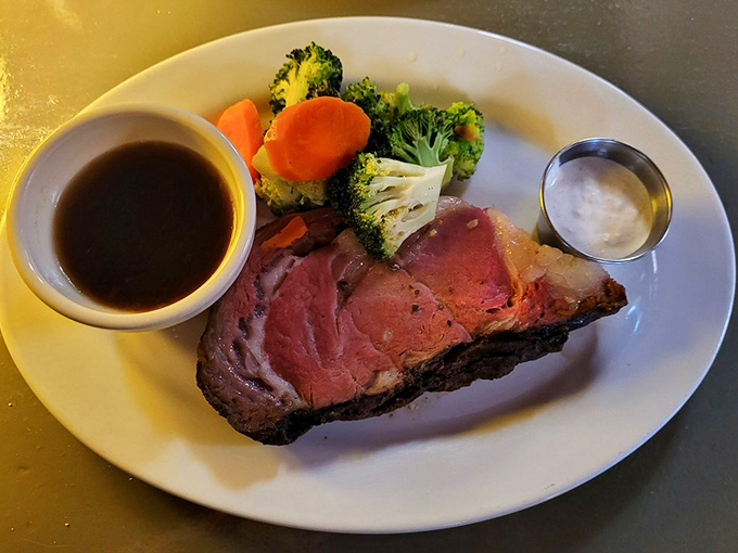 Prime rib so perfectly pink it belongs in a museum of meat masterpieces. That little cup of au jus is just waiting to elevate each bite from excellent to transcendent.