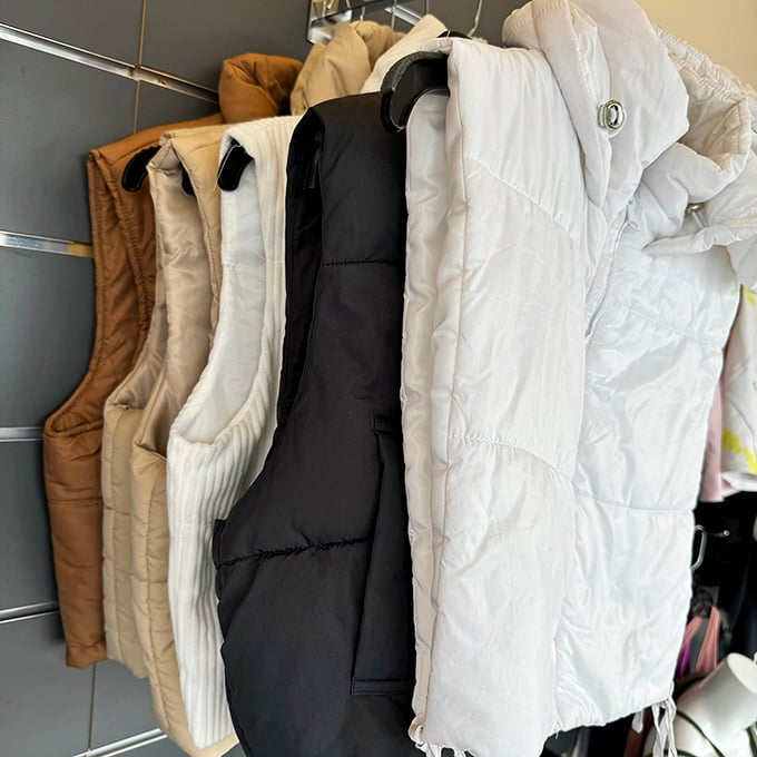 Puffer vest paradise! These quilted wonders wait patiently for their chance to keep someone stylishly warm without the retail markup.