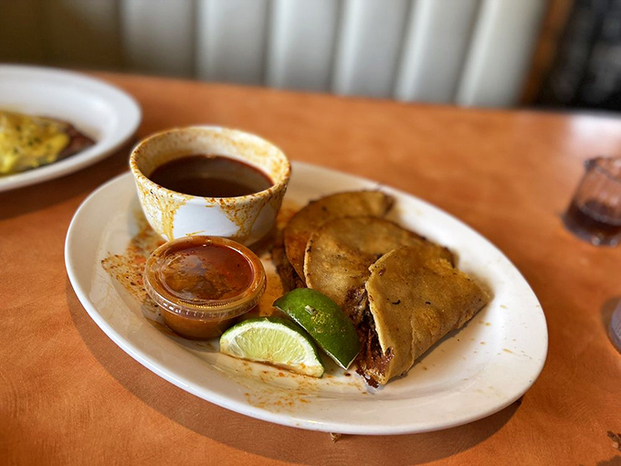 Quesabirria tacos: crispy, cheesy, meaty perfection with that essential lime wedge. Dip, bite, repeat&mdash;breakfast's new best friend.