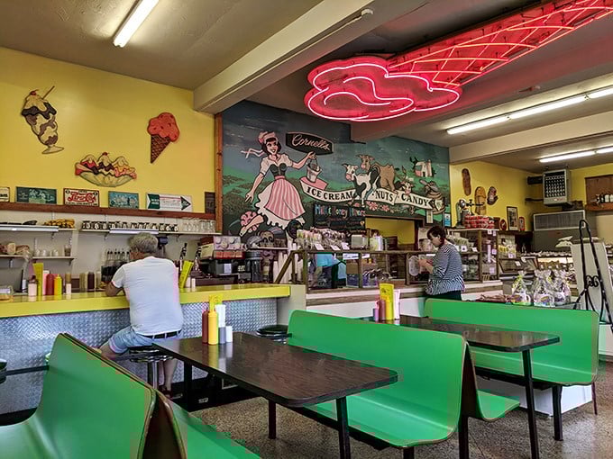 The neon ice cream cone sign glows like a beacon of hope in a world of chain restaurants and frozen yogurt pretenders.