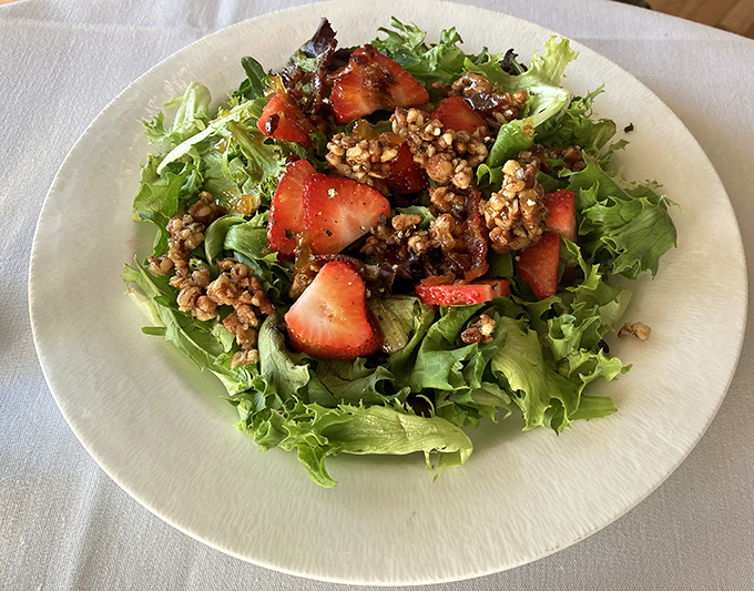 A salad that actually excites&mdash;fresh greens, sweet strawberries, and candied nuts creating a symphony of textures that makes eating vegetables feel indulgent.